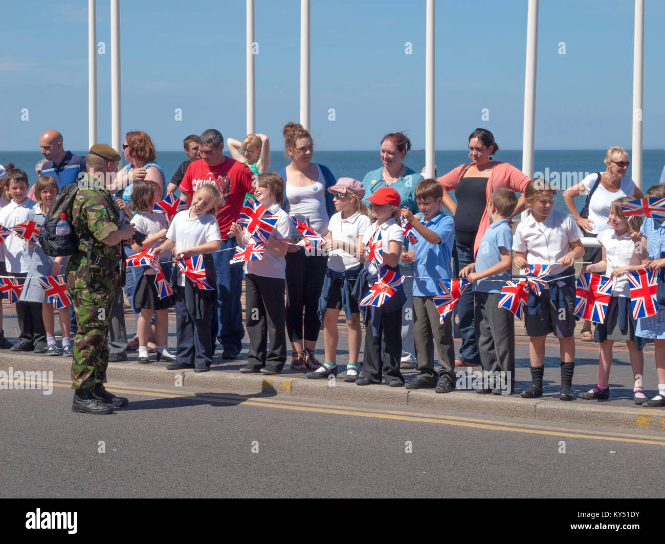School children with Union Flags meet a soldier at parade of the ...