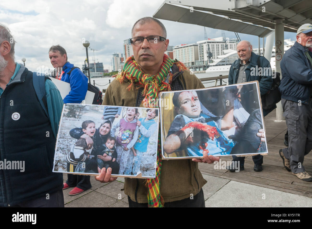 Protesters hold posters showing Turkish atrocities at the protest ...