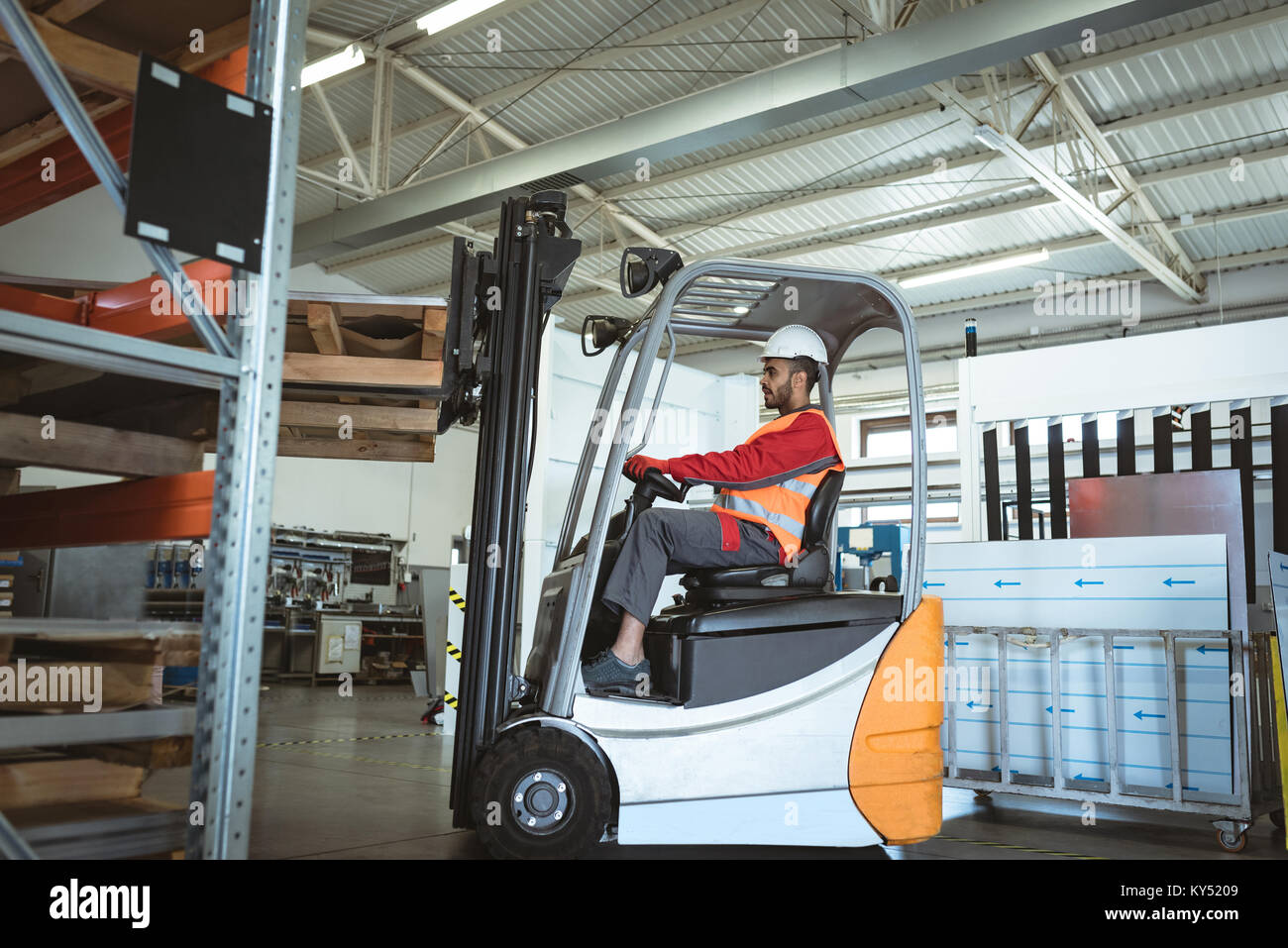 Male worker driving forklift Stock Photo - Alamy