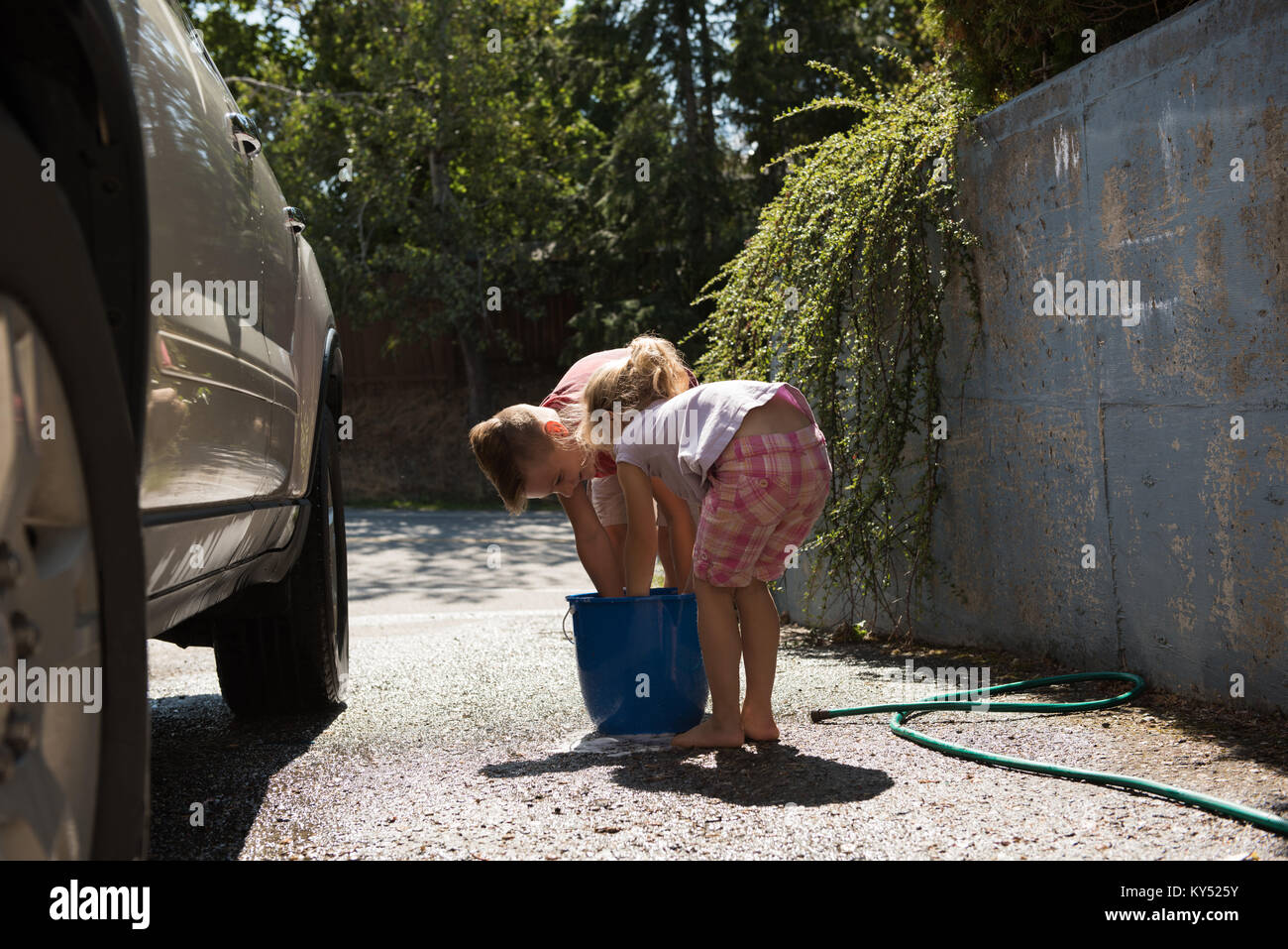 Siblings washing a car in outside garage Stock Photo - Alamy Siblings washing a car in outside garage Stock Photo - Alamy