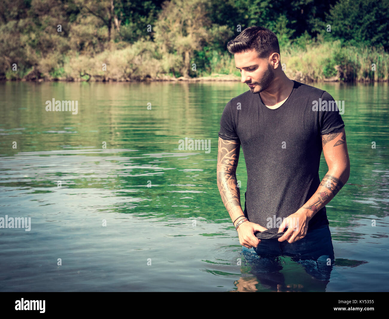 Handsome man in pond Stock Photo - Alamy
