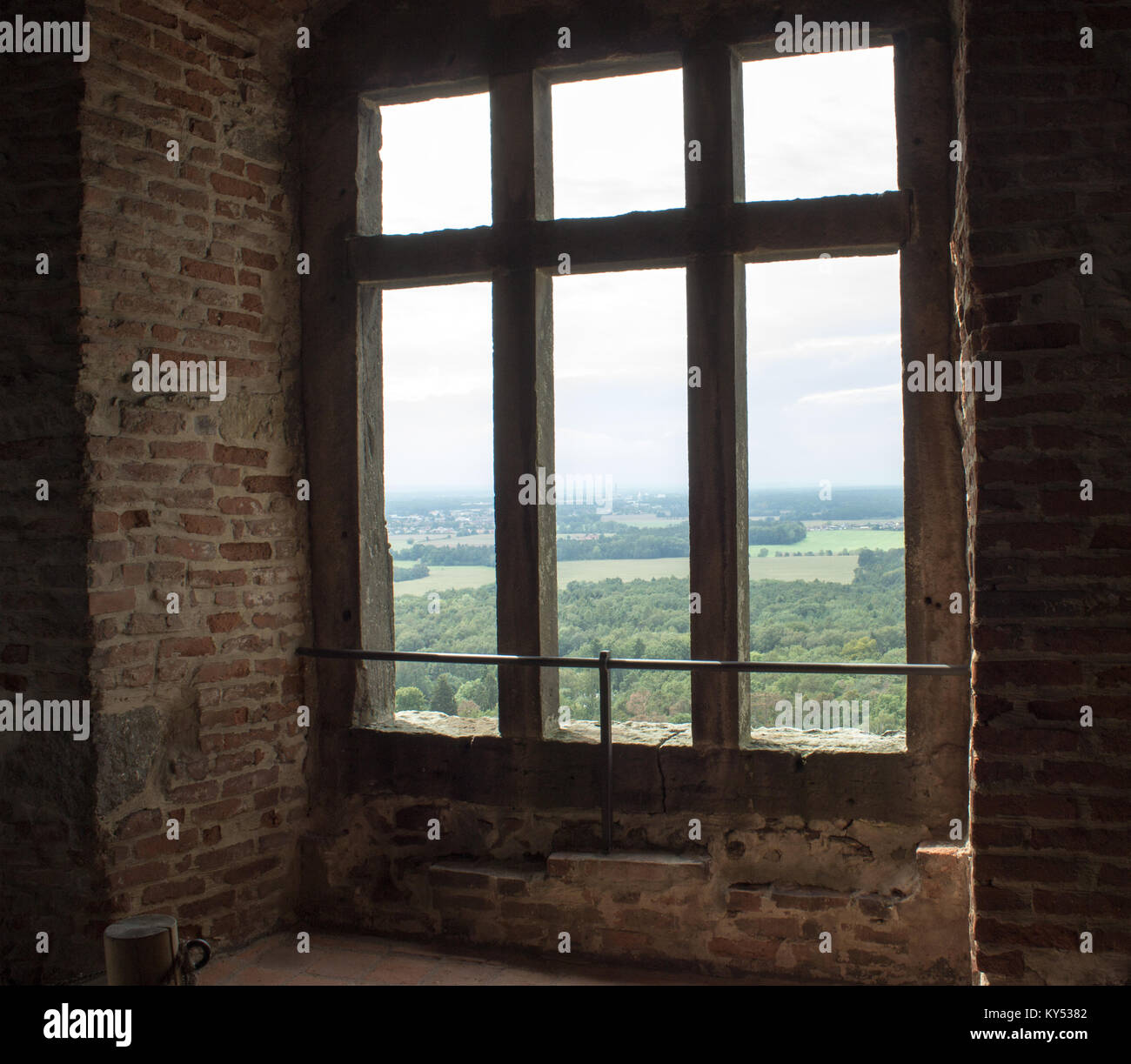 A view through a window in the brick wall into the landscape Stock ...