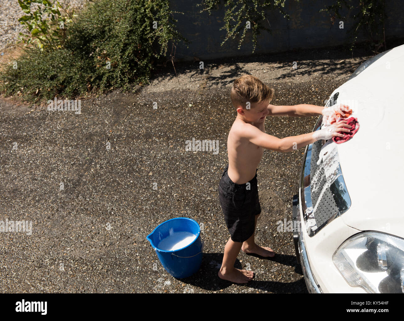 Boy washing a car at outside garage Stock Photo - Alamy