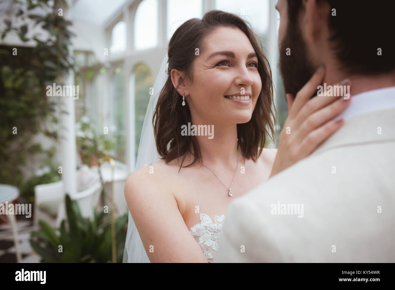 Smiling bride looking at the groom Stock Photo - Alamy