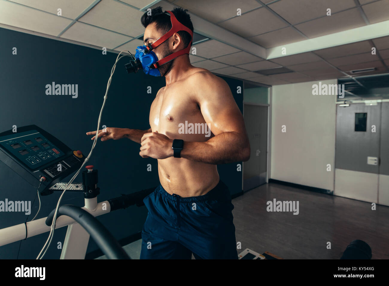 Professional athlete monitoring his performance in sports science lab ...
