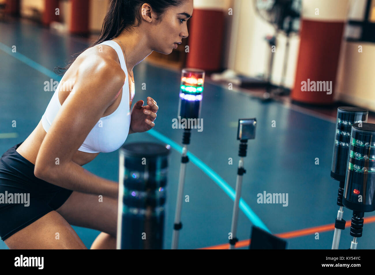 Female athlete using a visual stimulus system. Sportswoman at sports ...