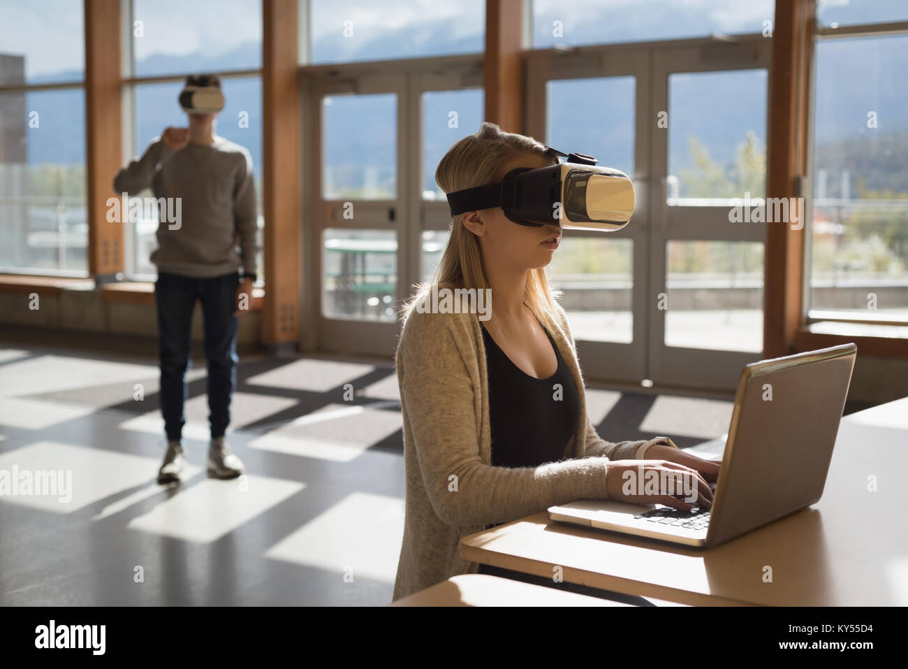University students using laptop and virtual reality headset Stock ...