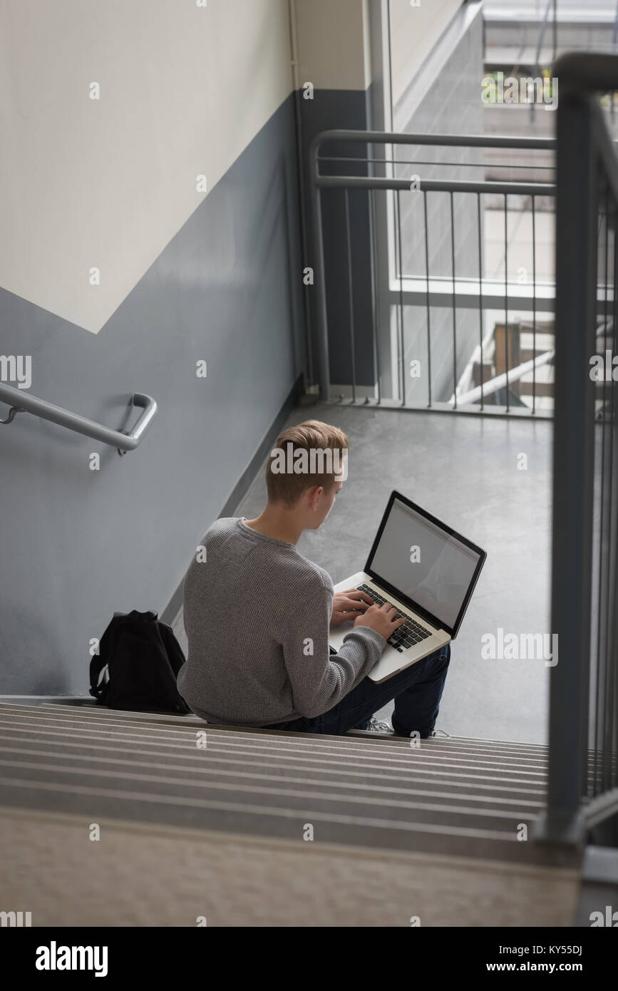 Rear view of teenage boy using laptop Stock Photo - Alamy