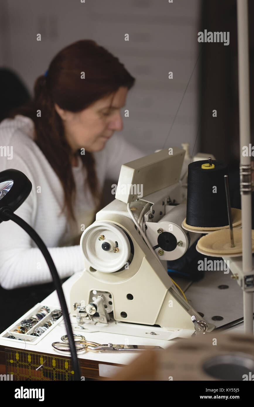 Tailor sewing jacket with sewing machine Stock Photo - Alamy