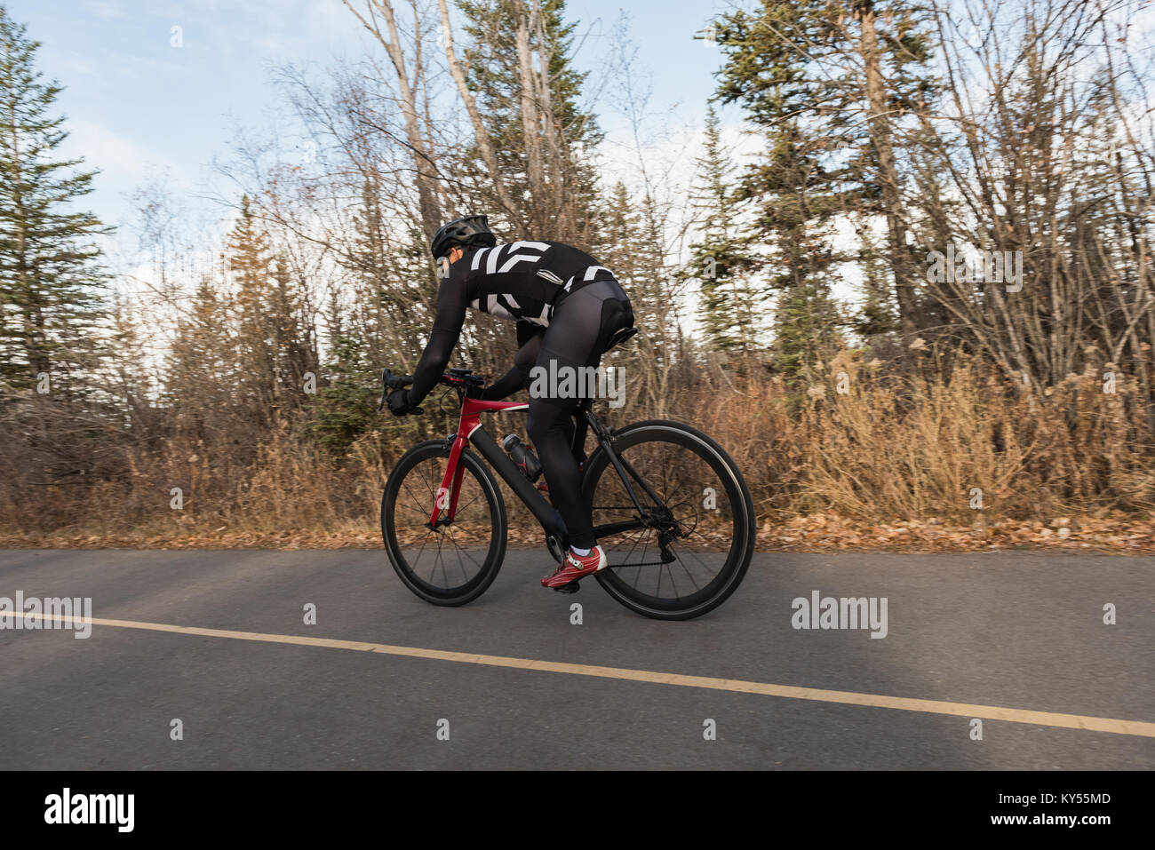 Biker riding mountain bike on road Stock Photo - Alamy