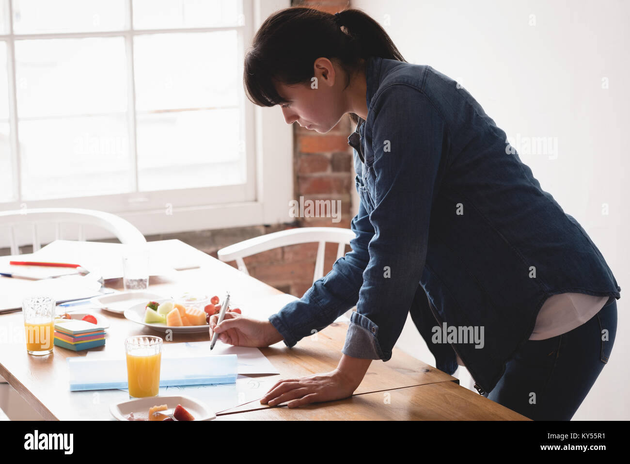 Female executive checking a documents Stock Photo - Alamy