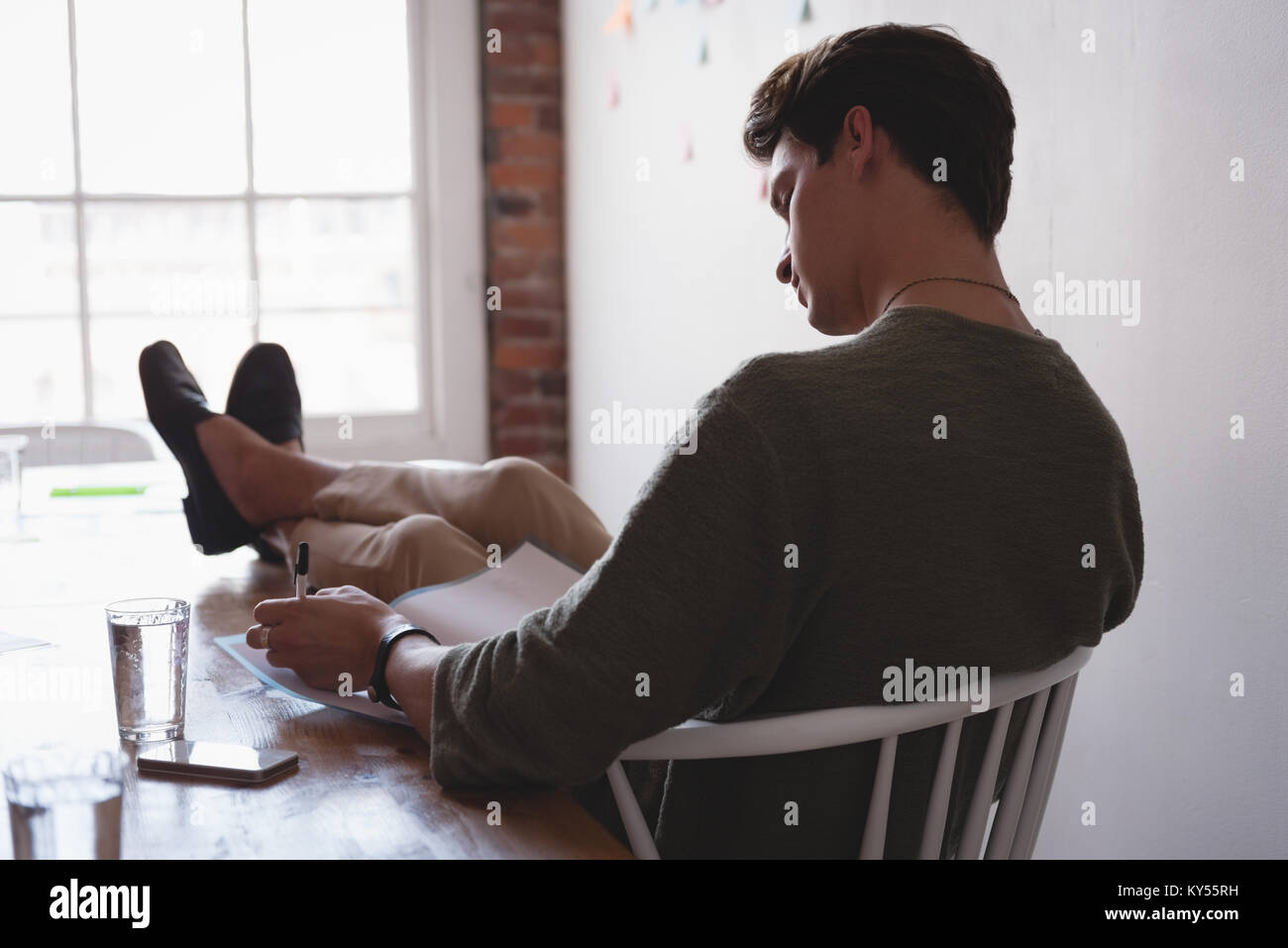 Man on chair feet table hi-res stock photography and images - Alamy