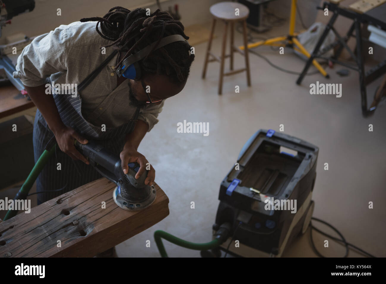 Carpenter leveling wood with polishing machine in workshop Stock Photo ...