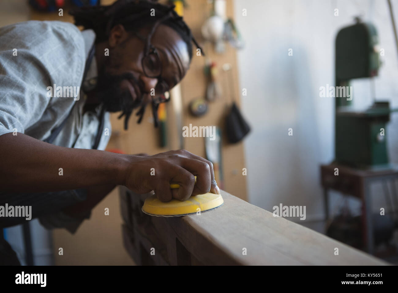 Carpenter leveling wood with work tool Stock Photo - Alamy