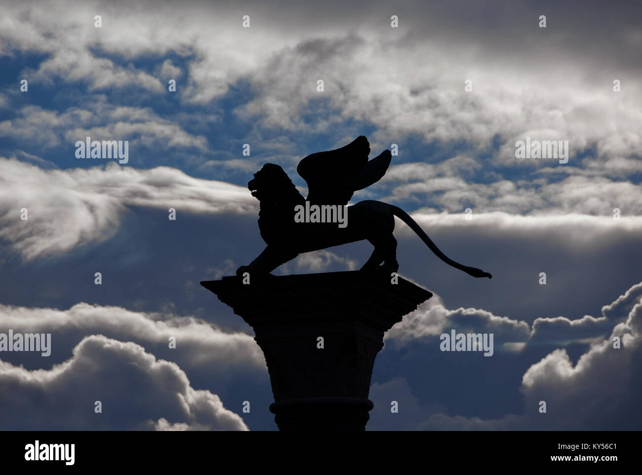 Saint Mark Winged Lion old medieval statue silhouette among clouds ...