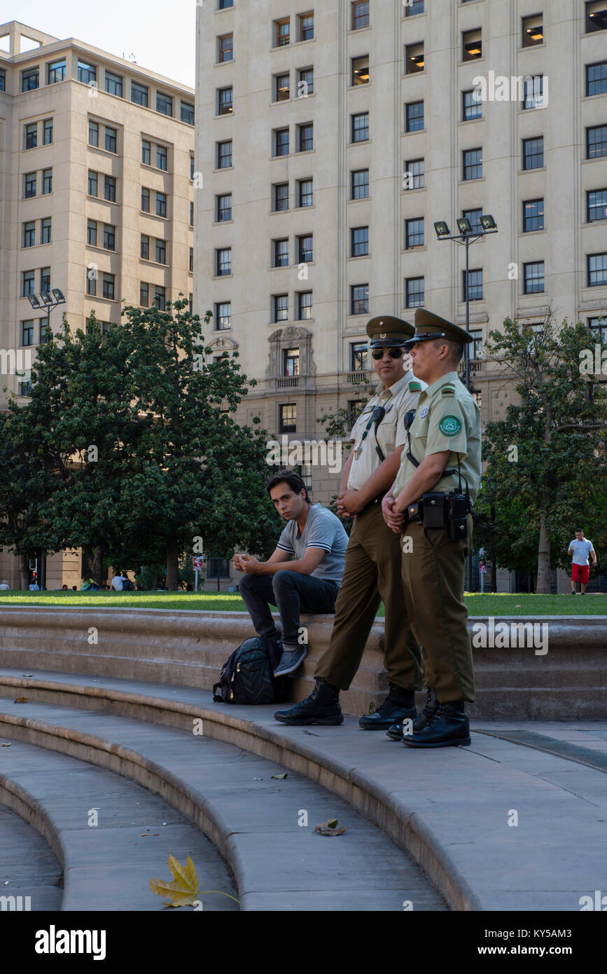 Police stand guard with a bystander at the Plaza de la Constitucion ...