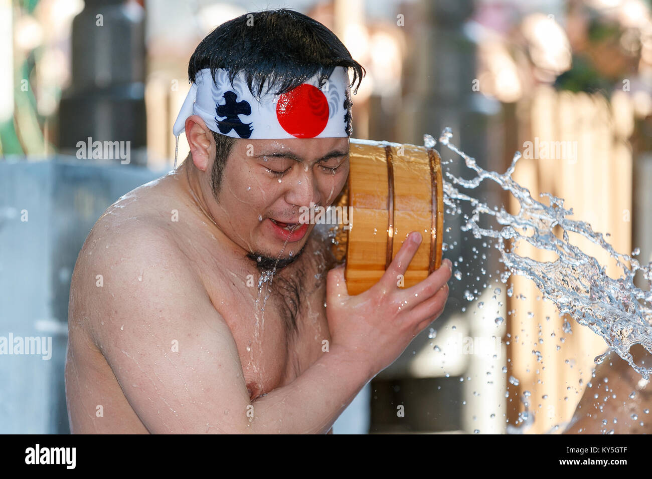 Tokyo, Japan. January 13, 2018. A participant pours cold water over ...
