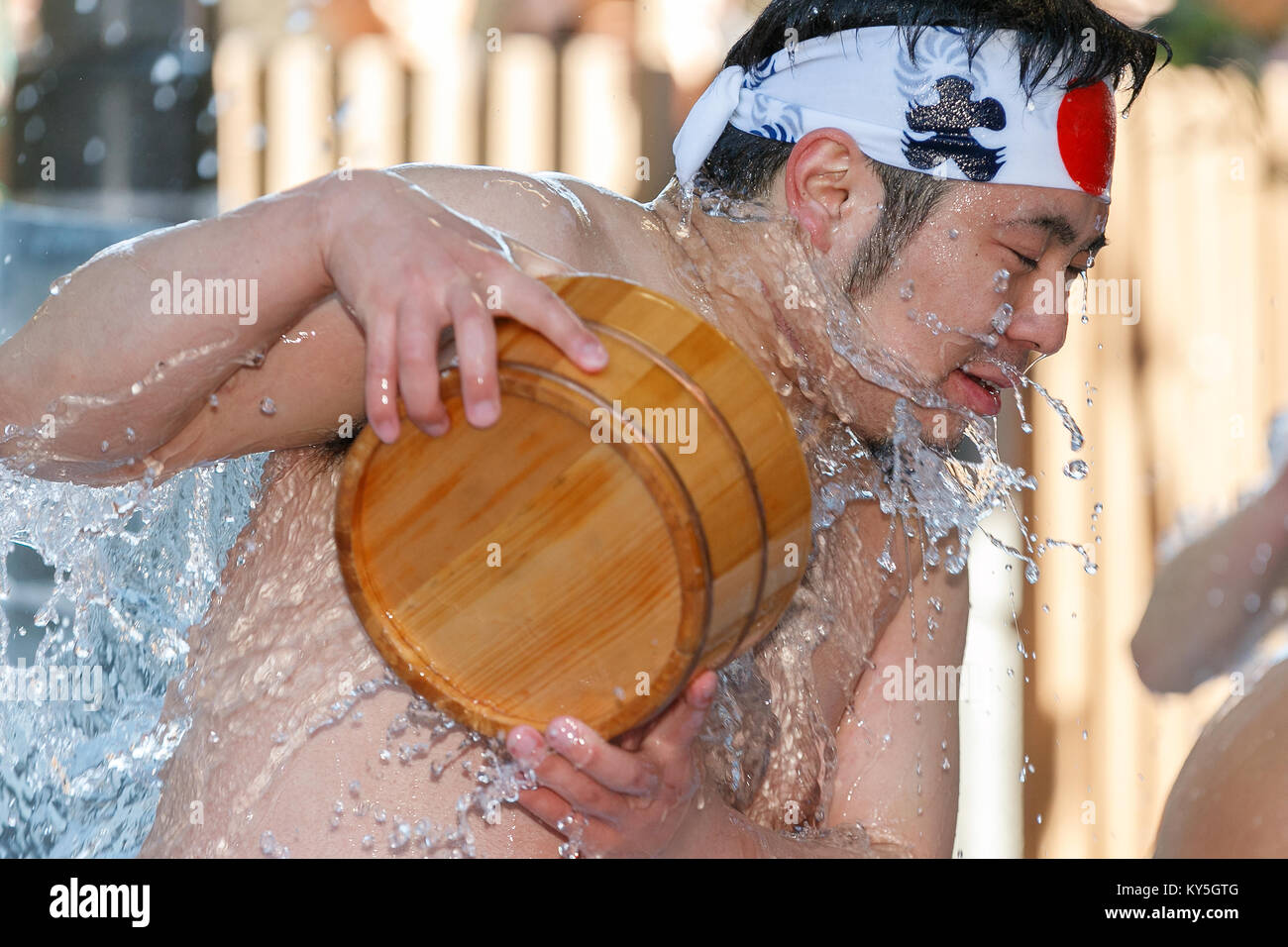Tokyo, Japan. January 13, 2018. A participant pours cold water over ...
