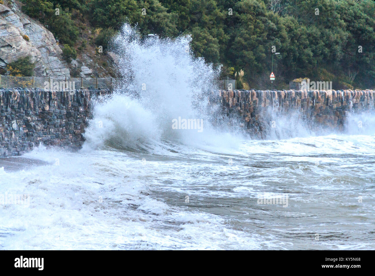 Waves breach the sea wall at Meadfoot Beach in Torquay, Torbay, Devon ...