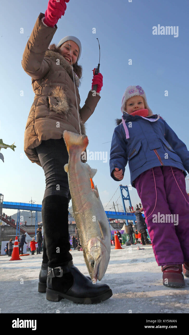 14th Jan, 2018. Ice fishing fest A foreign tourist shows off a trout at ...