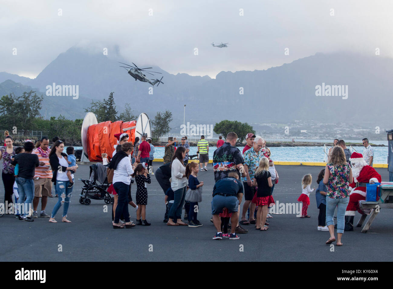 U.S. Marines and their families wait in line to meet Santa at a unit ...