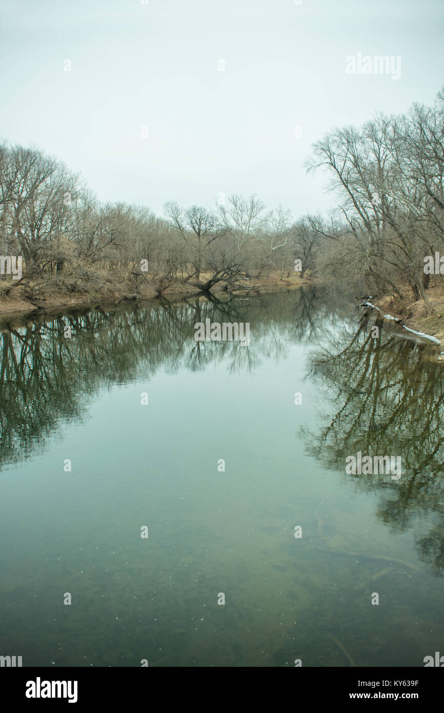 A small shallow river with banks of trees Stock Photo - Alamy