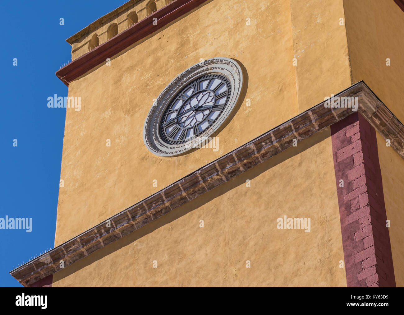 An isolated, close-up of the very yellow clock tower with architectural ...