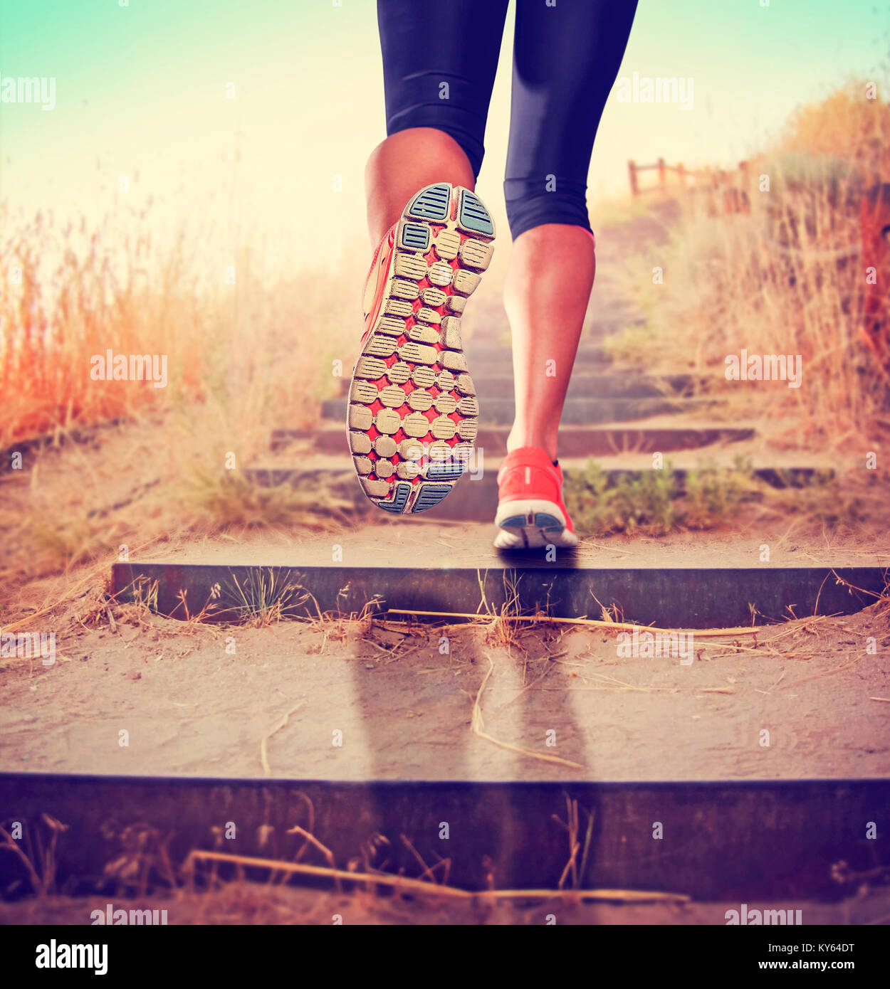 a woman with an athletic pair of legs going for a jog or run during ...