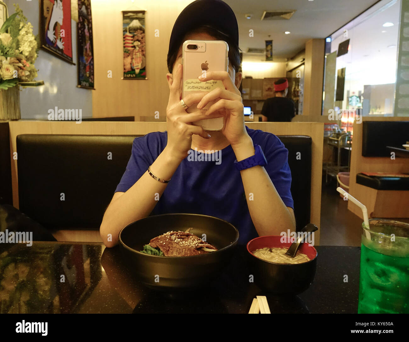 Bangkok, Thailand - Jun 18, 2017. A man using mobile at noodle ...