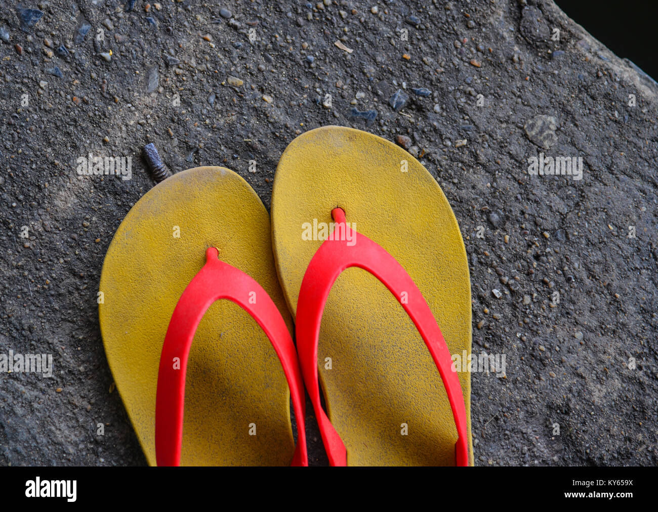 Old yellow flip flop on street in Bangkok, Thailand Stock Photo - Alamy