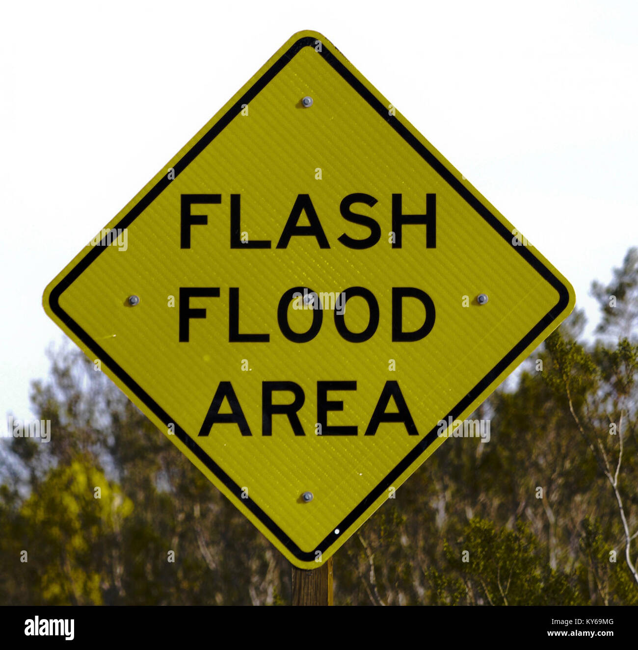 Bright Yellow Triangular Sign on the desert highway warning of flash ...