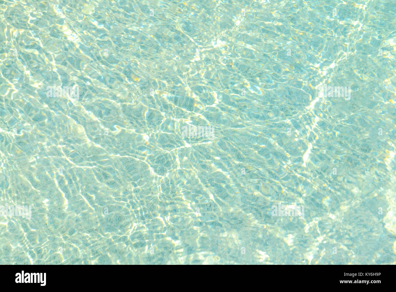 Swimming pool blue water with a wave and sunlight reflection effect ...