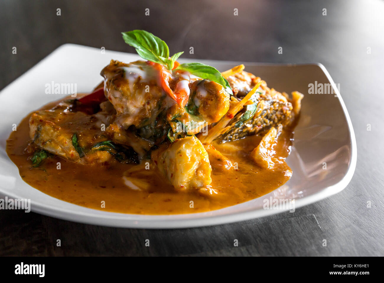 Fried grouper Fish with Red Curry Paste Chu Chee Pla Stock Photo - Alamy