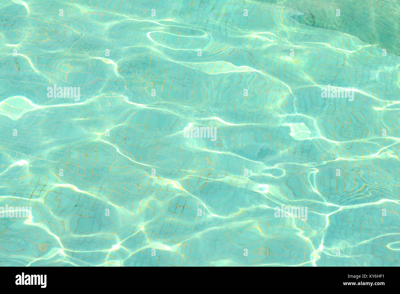 Swimming pool blue water with a wave and sunlight reflection effect ...