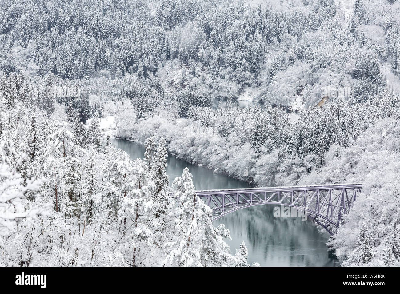 Winter landscape snow covered trees with train crossin River on Bridge ...