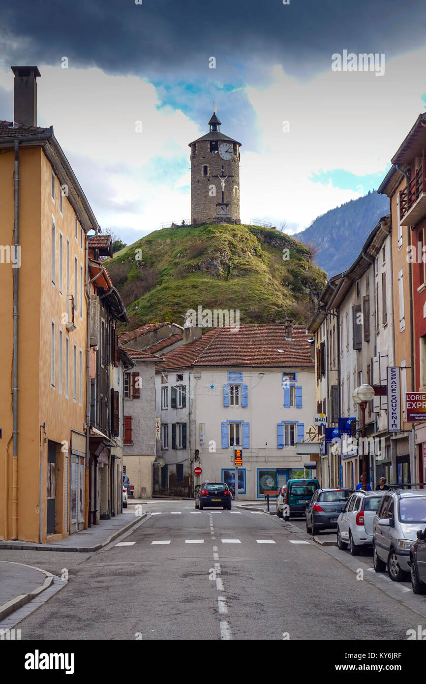 Street with old houses and clock tower on hill, Tarascon sur Ariege ...