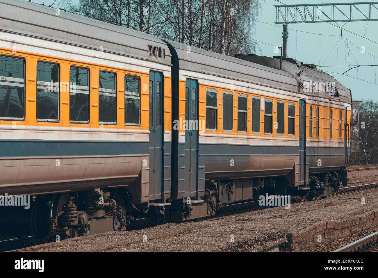 Old yellow passenger diesel train moving at the terminal Stock Photo ...