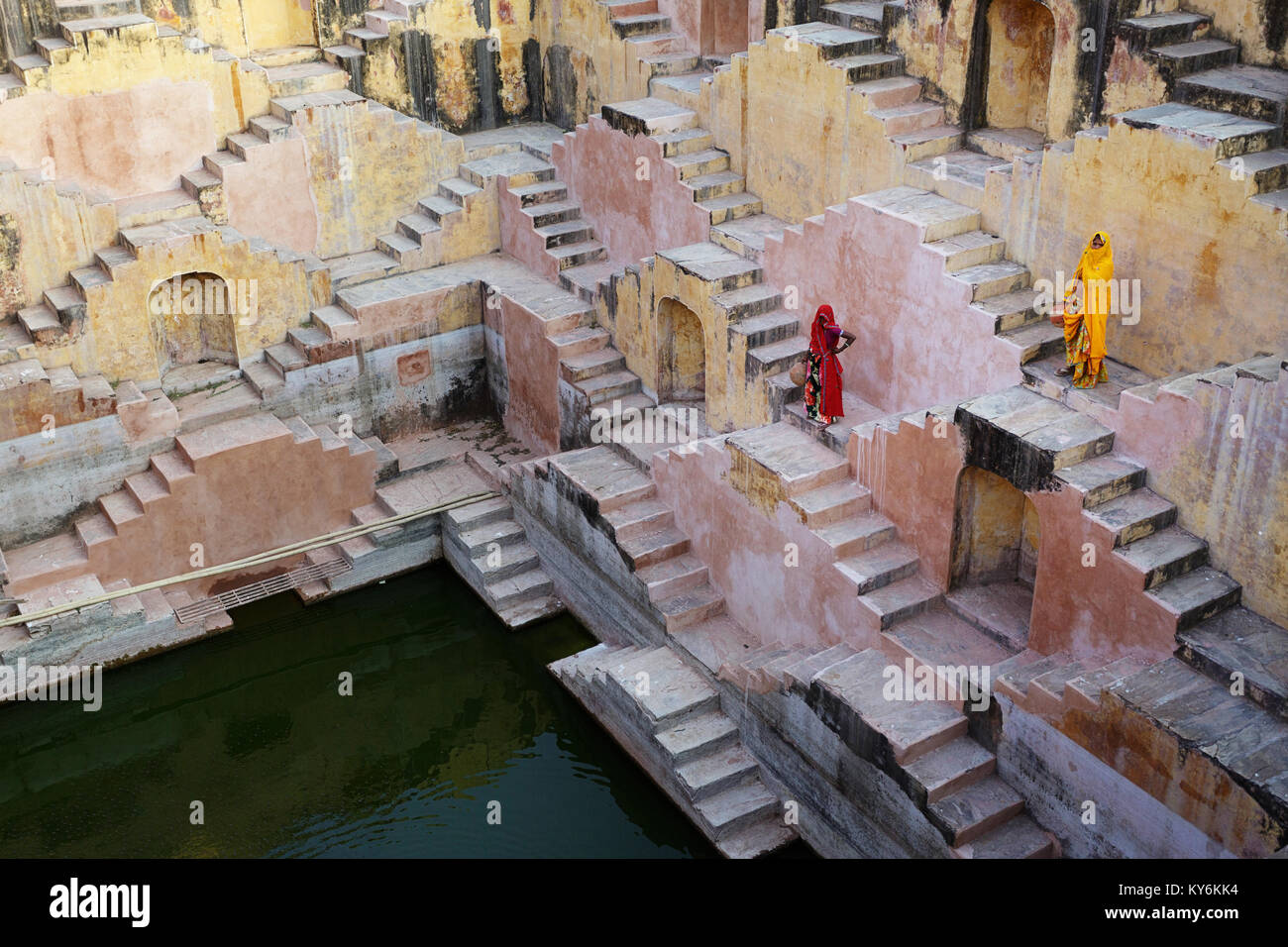 Two local women in traditional dress walking at the stepwell Panna ...