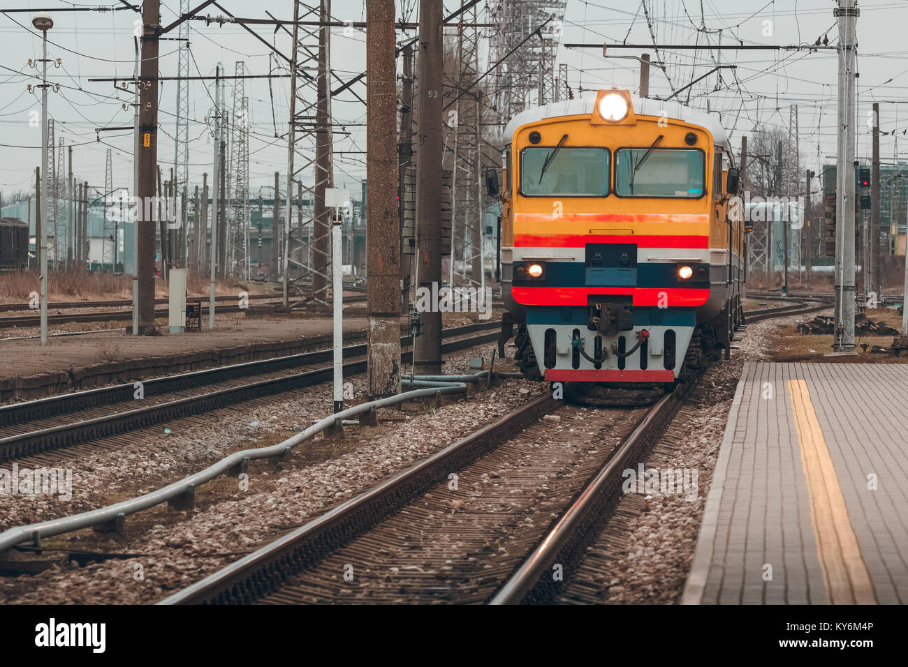 Old yellow passenger diesel train moving at the terminal Stock Photo ...