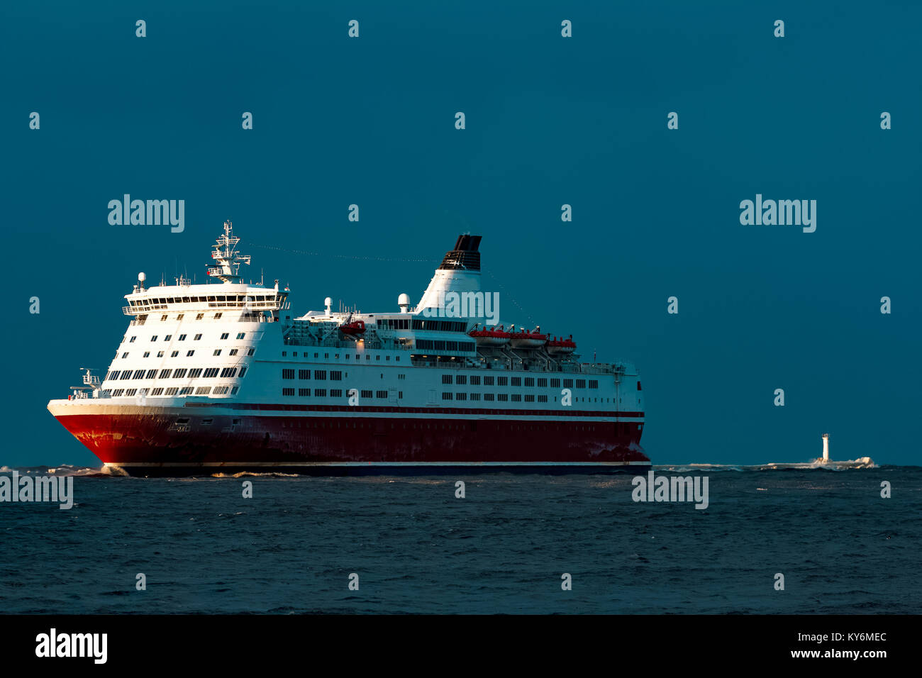 Red cruise liner. Passenger ship sailing from the sea in the morning ...