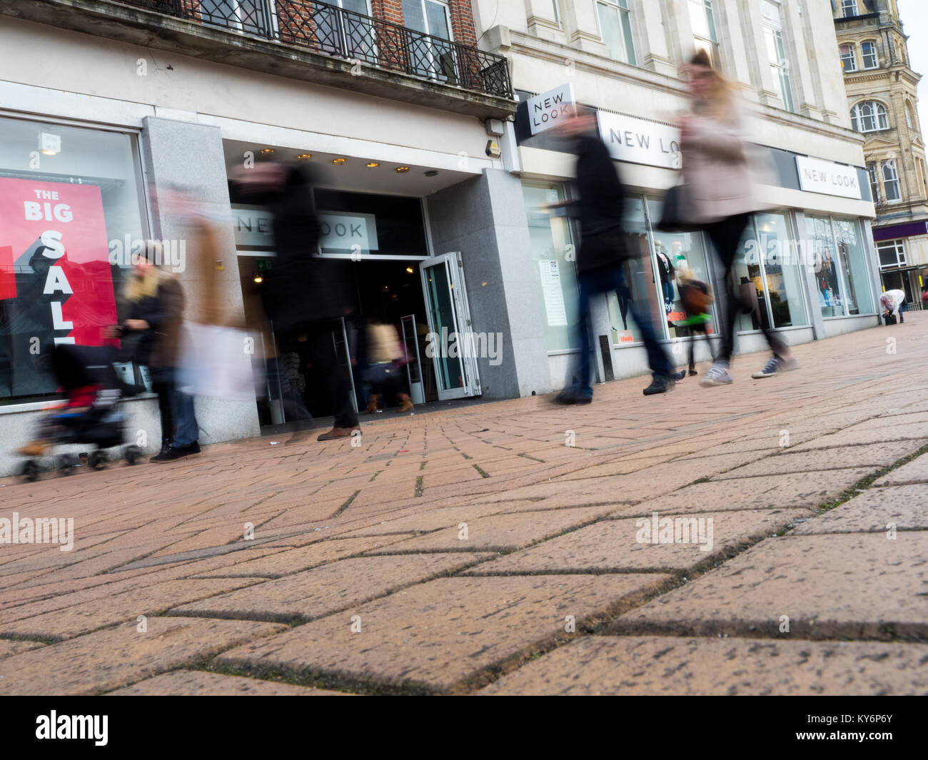 Blurred people walking past a New Look store Stock Photo - Alamy
