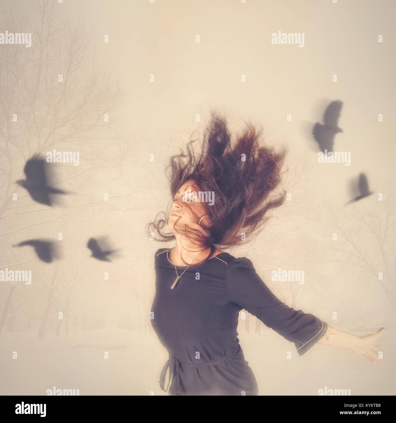 a woman with brids flying around her head Stock Photo - Alamy