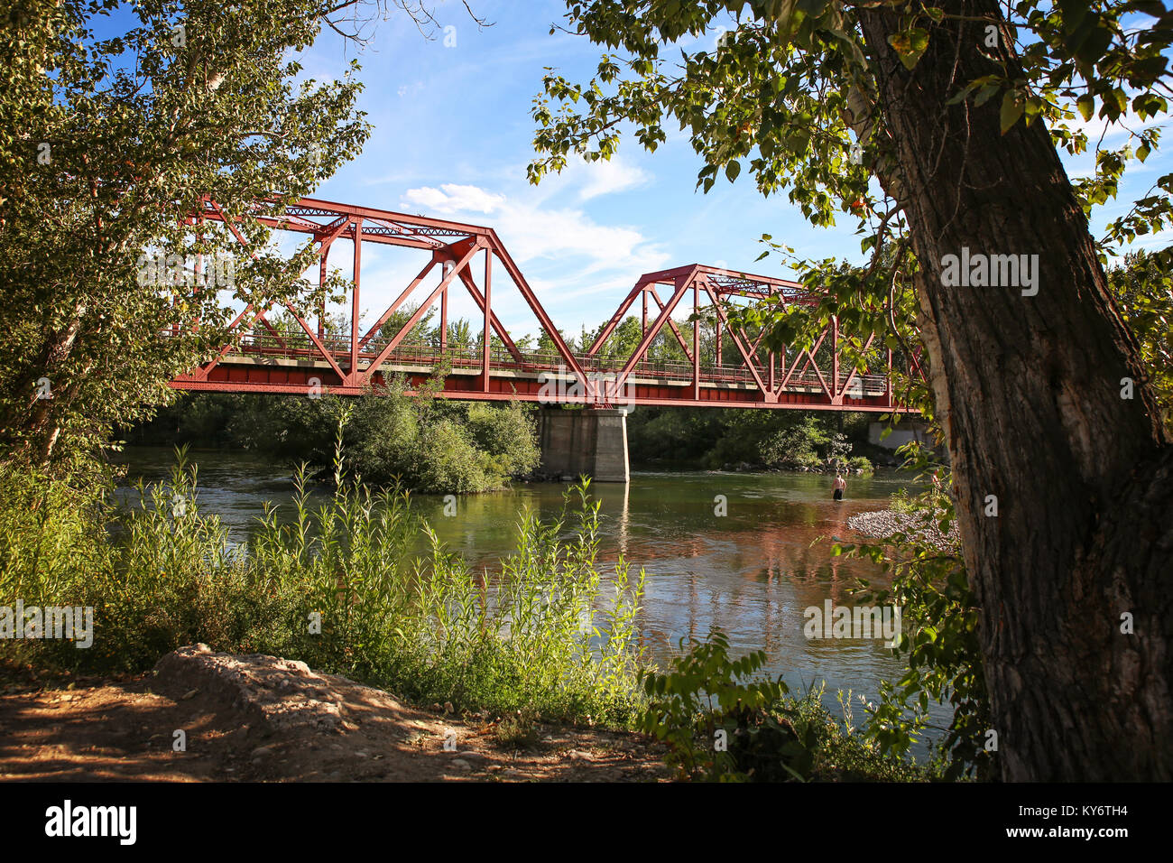 a beautiful park river and a train trestle bridge toned with a retro ...