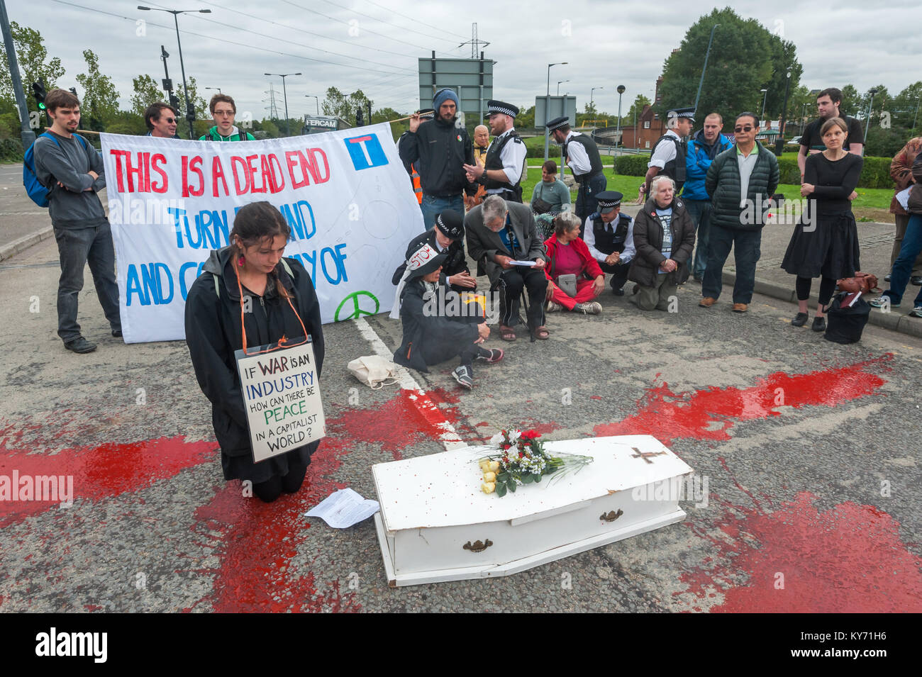 Police come and talk to the people blocking the road, telling them they ...