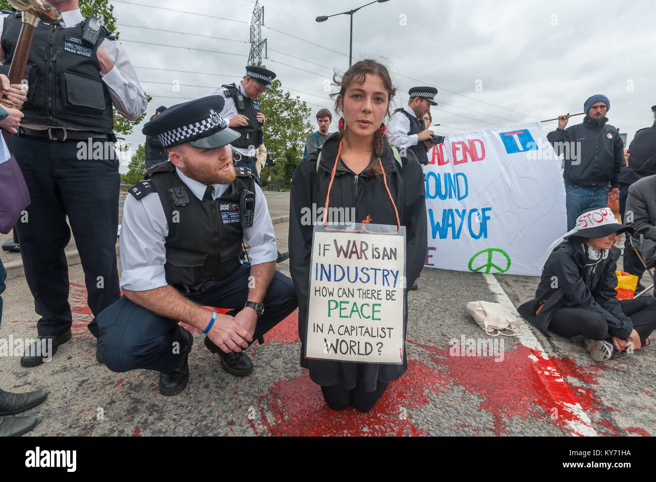 Police come and talk to the people blocking the road, telling them they ...