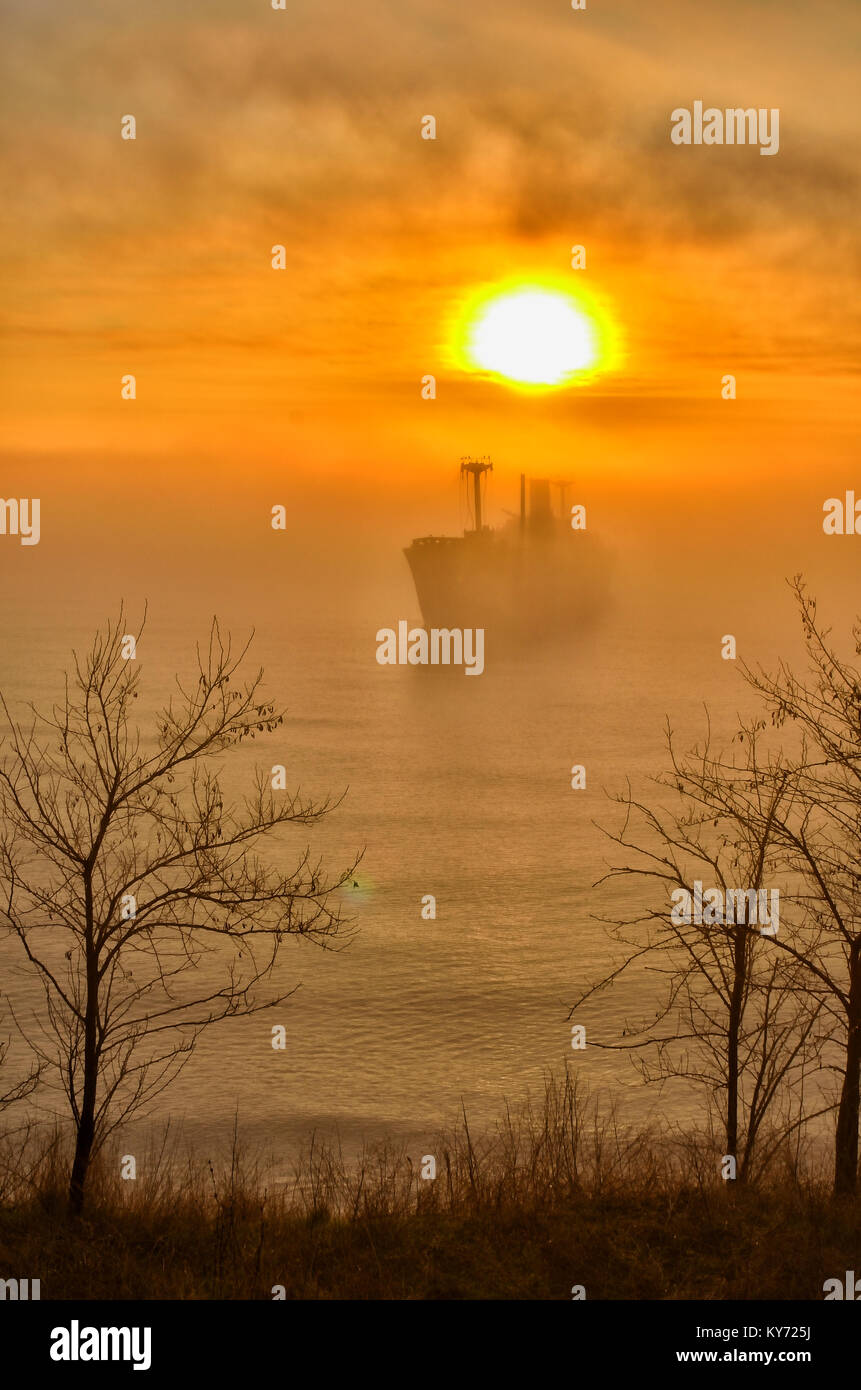 Beautiful sunrise haze with a greek shipwreck Evangelia on the shore of ...