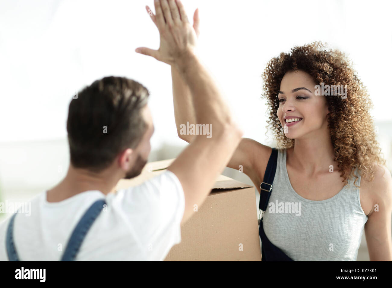 Happy and young couple giving a high five Stock Photo - Alamy