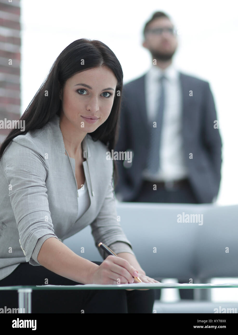 business woman signs documents in a modern office Stock Photo - Alamy