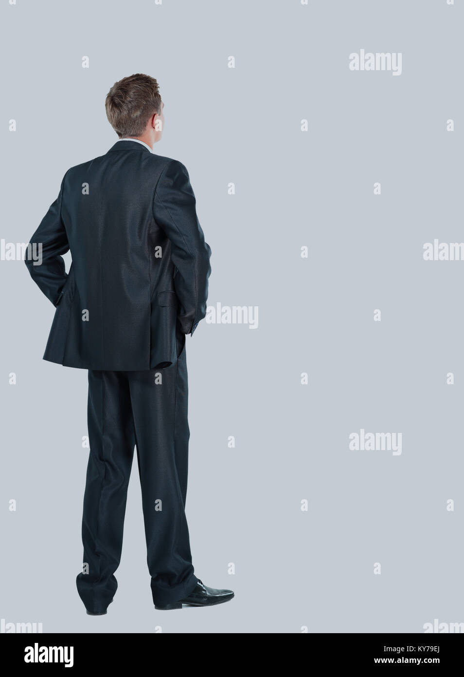 business man from the back - looking at something over a white ...