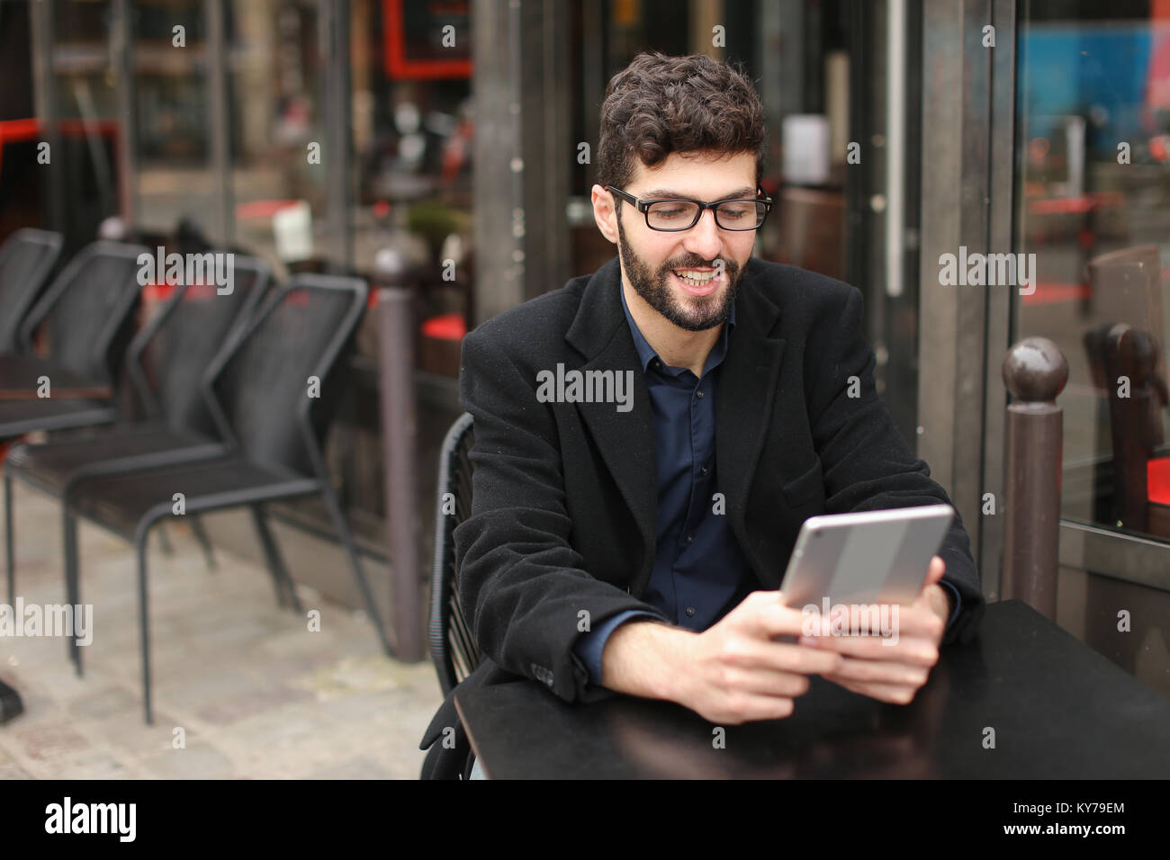 Male graphic designer working with order papers and modern tablet in ...